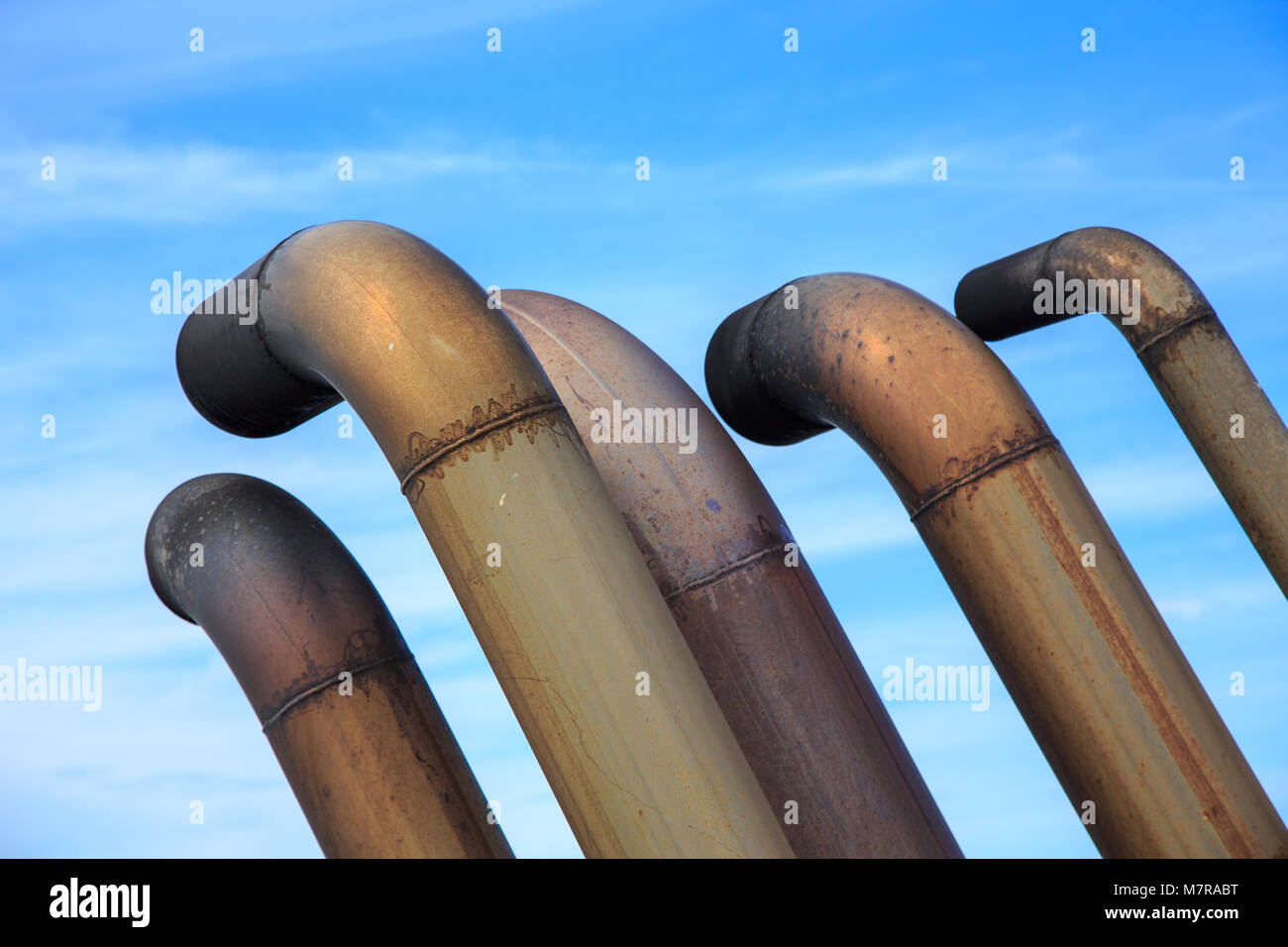 Close up of rusty metal boat pipes on blue sky background Stock Photo ...
