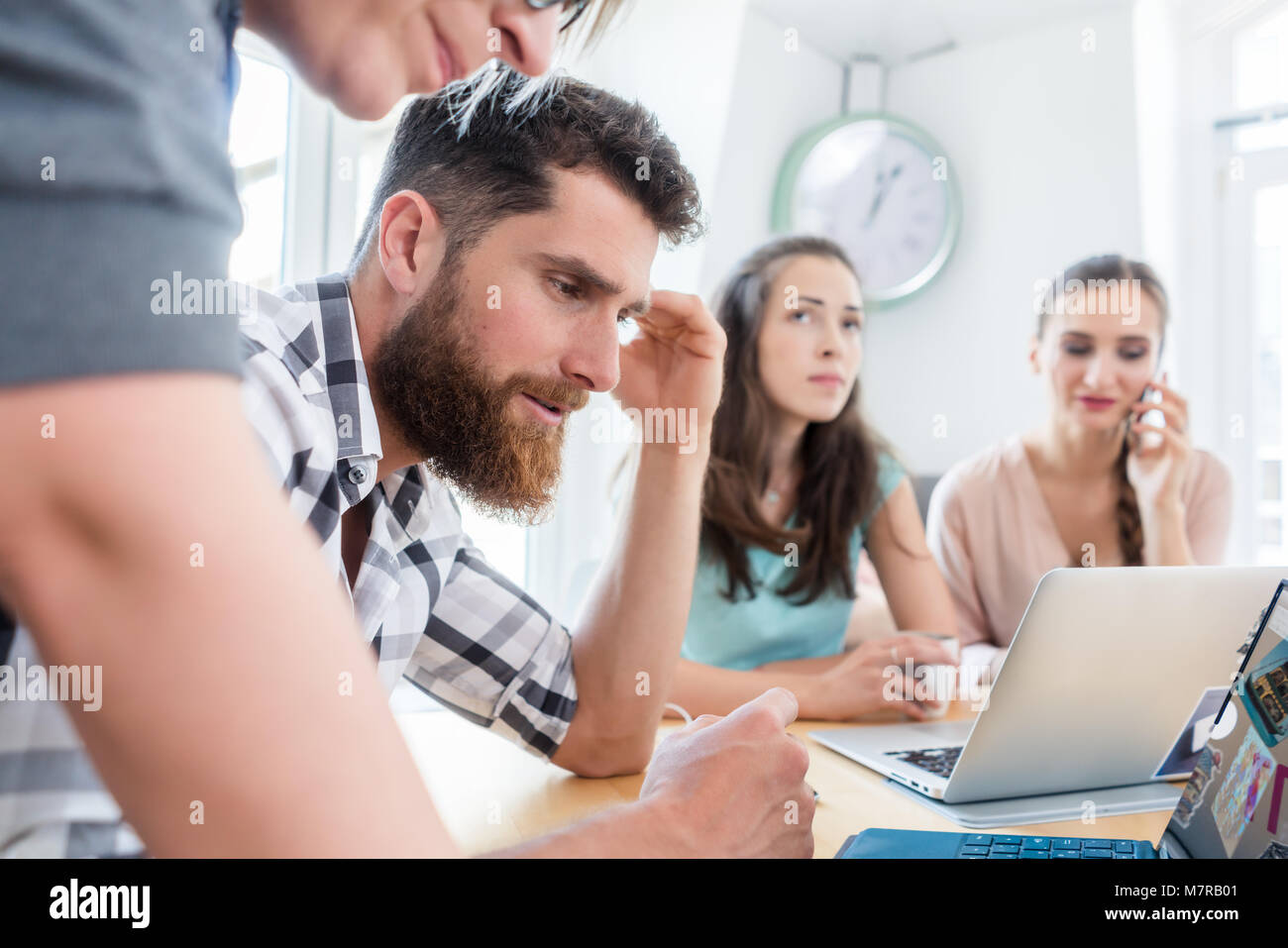 Self-employed young man analyzing a difficult task while working Stock ...