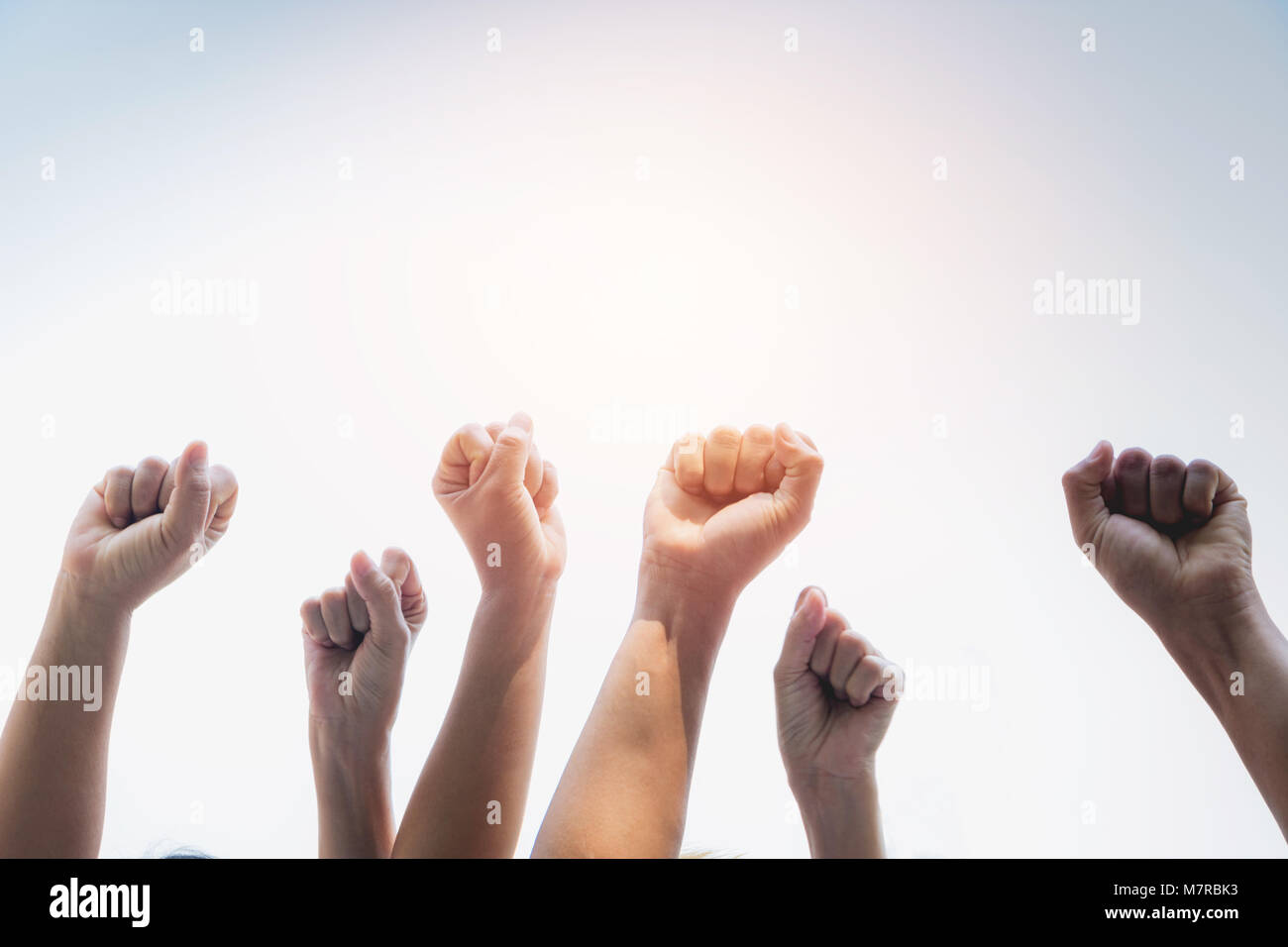Hand of people arm raising up showing power strong with sky background ...