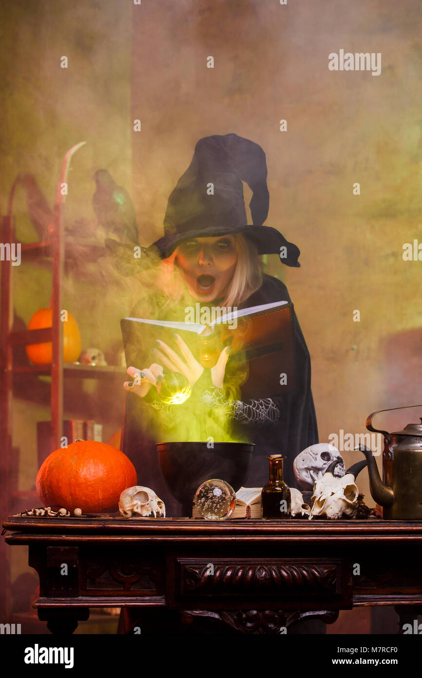 Portrait of witch on cauldron with steam Stock Photo - Alamy