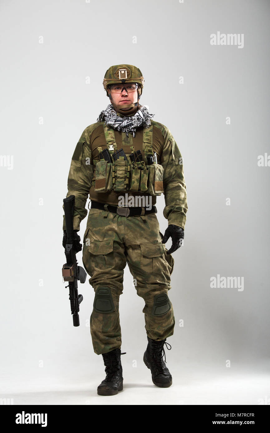 Full-length picture of soldier with gun in his hand Stock Photo - Alamy