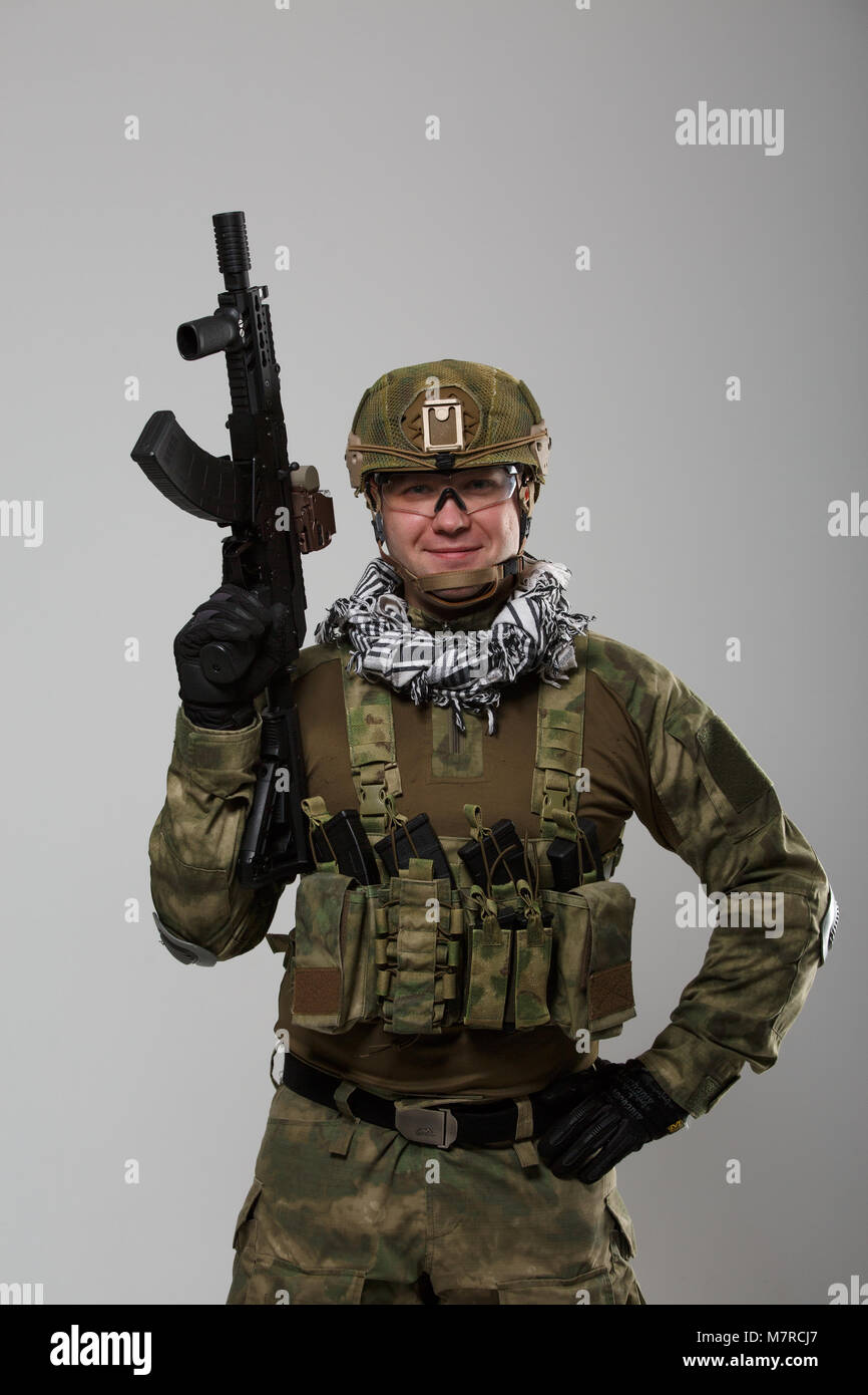 Picture of military man with gun in studio Stock Photo - Alamy
