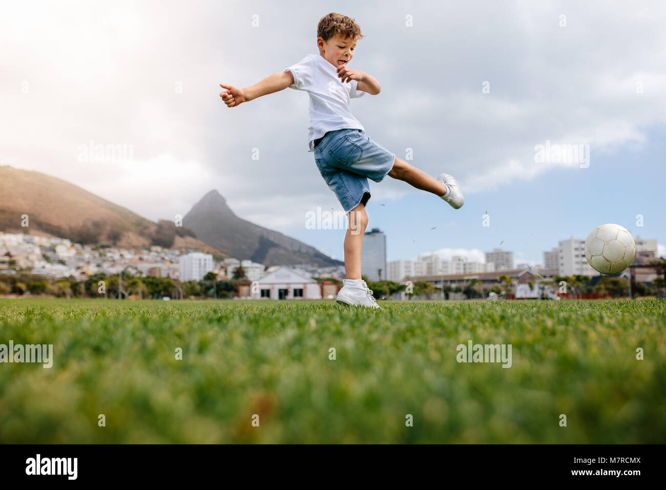 Boy playing football hi-res stock photography and images - Alamy