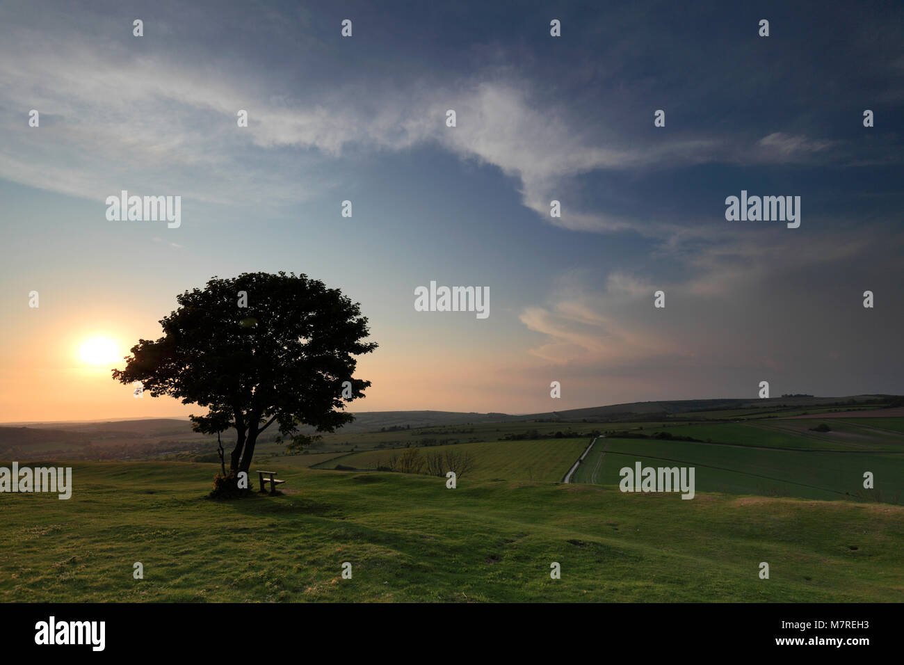 Sunset over the village of Findon from Cissbury Ring, South Downs ...