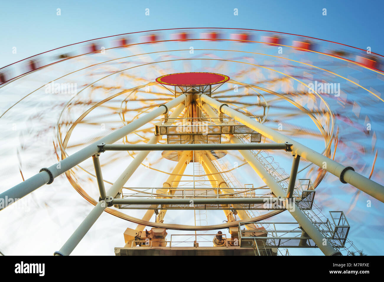 Blurred in Motion Ferris Wheel in the Amusement Park at Sunset. Long ...