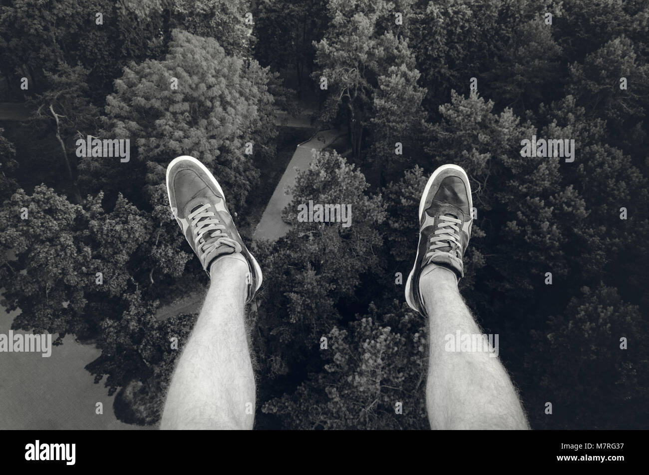 Feet Hanging in the Air First Person View. Above the City Park. The ...