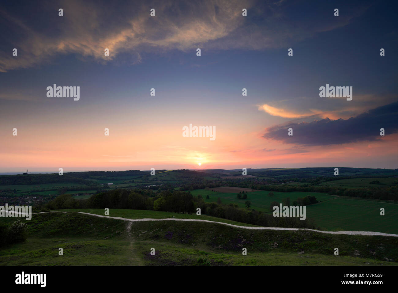 Sunset over the village of Findon from Cissbury Ring, South Downs ...