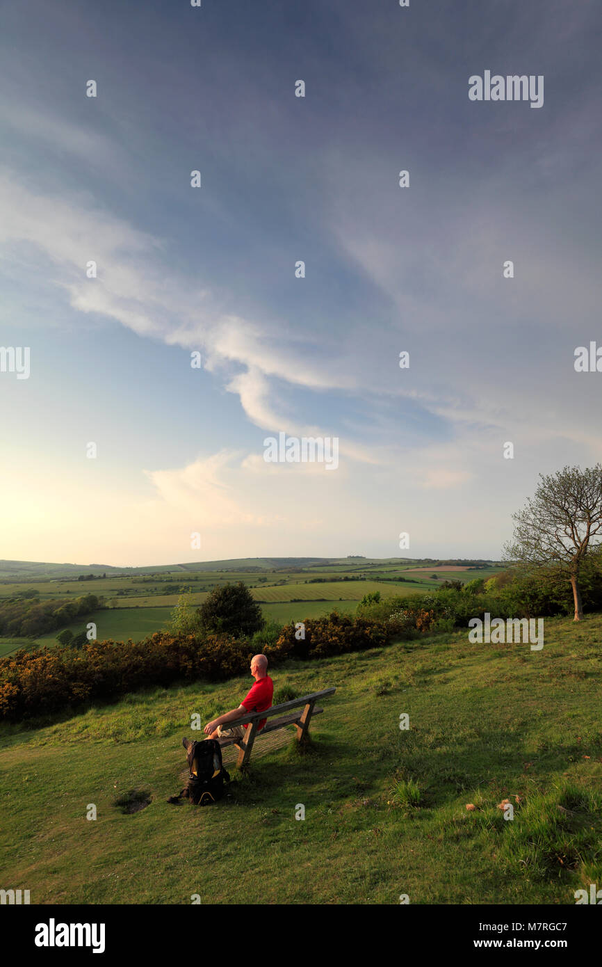 Walker at Cissbury Ring, near Findon village, South Downs National Park ...