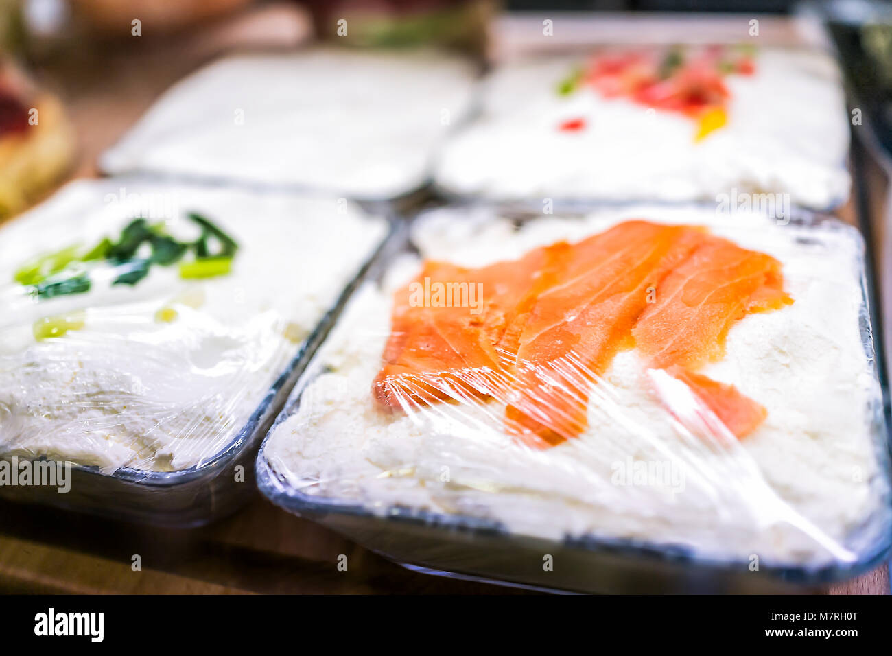 Macro closeup of plastic wrapped farmed salmon dip cream cheese on ...