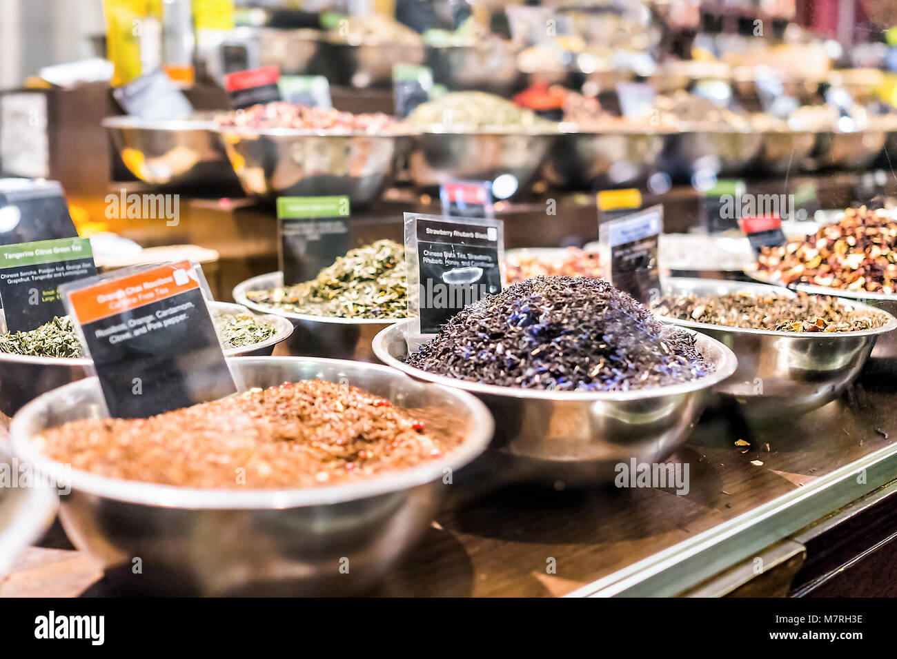 Closeup of black herbal tea spices on display in metal bowl tray filled ...