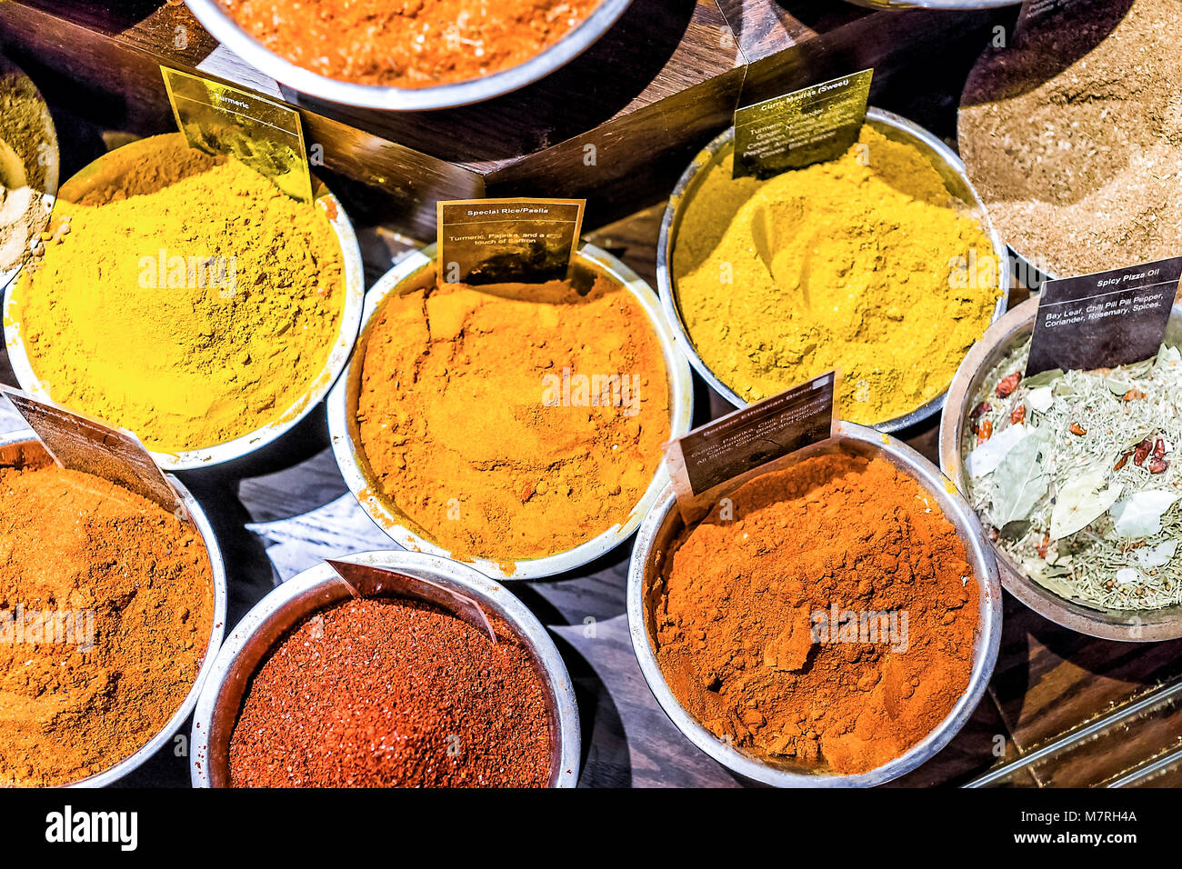 Many spices flat lay top view down on display in bowls trays filled ...