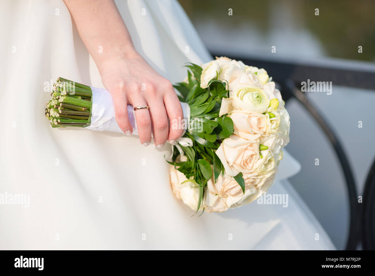 Bouquet of white roses being held by a bride Stock Photo - Alamy
