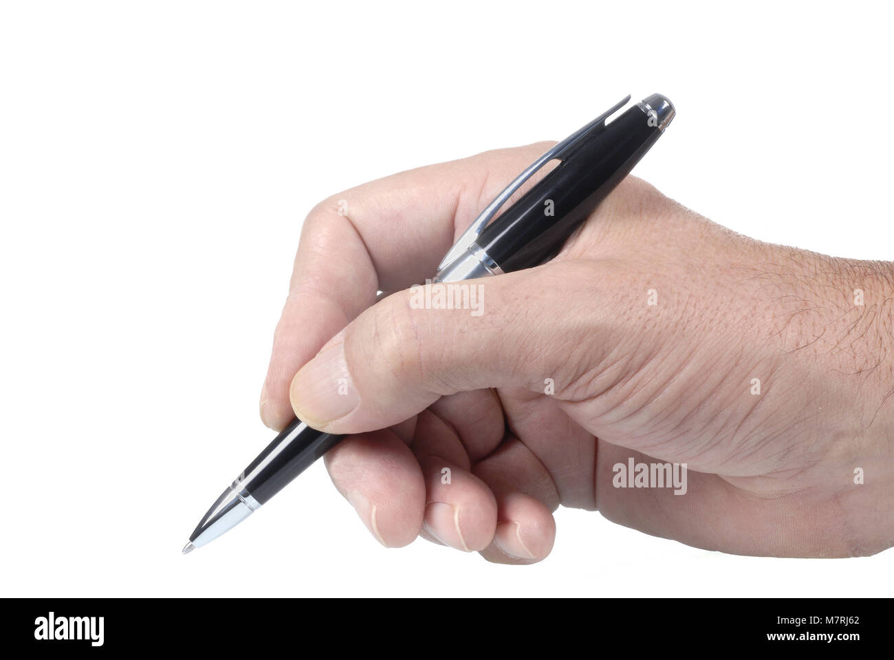 Black ballpoint pen held in a writing position by a male hand isolated ...