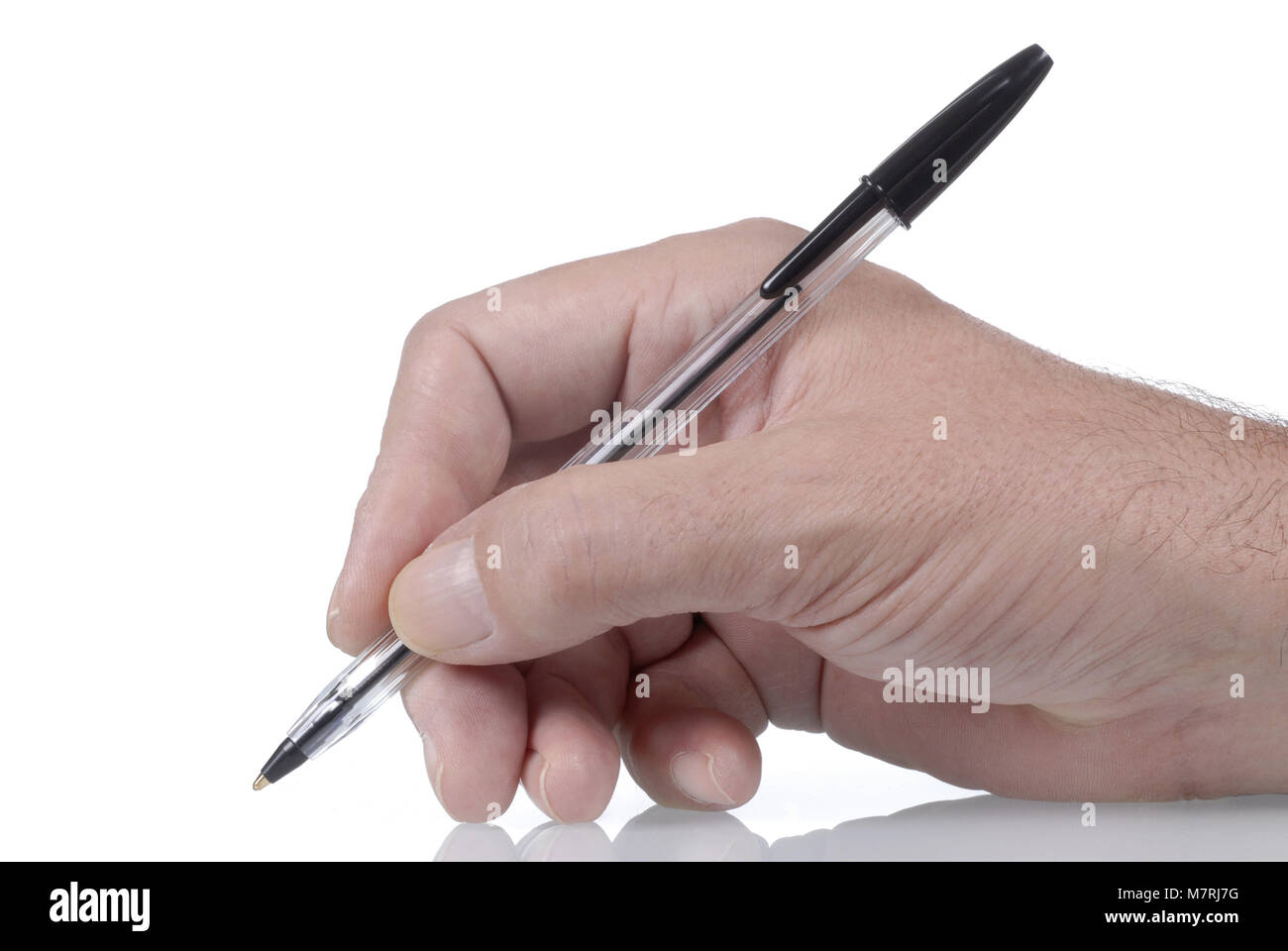 Black ordinary ballpoint pen held in a writing position by a male hand ...