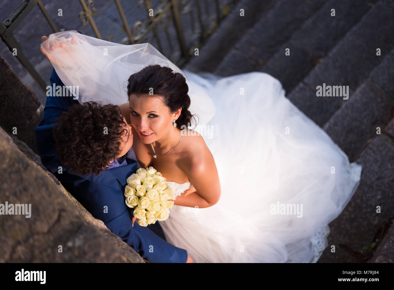 Just married couple huddling Stock Photo - Alamy