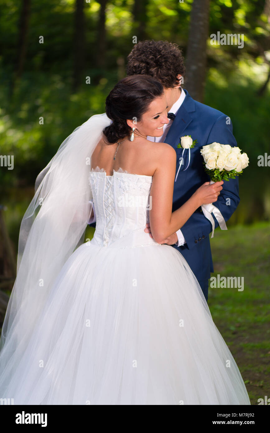 Just married couple huddling Stock Photo - Alamy