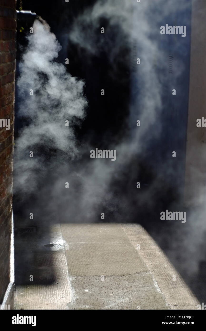 Swirling mist in a dark alley Stock Photo - Alamy
