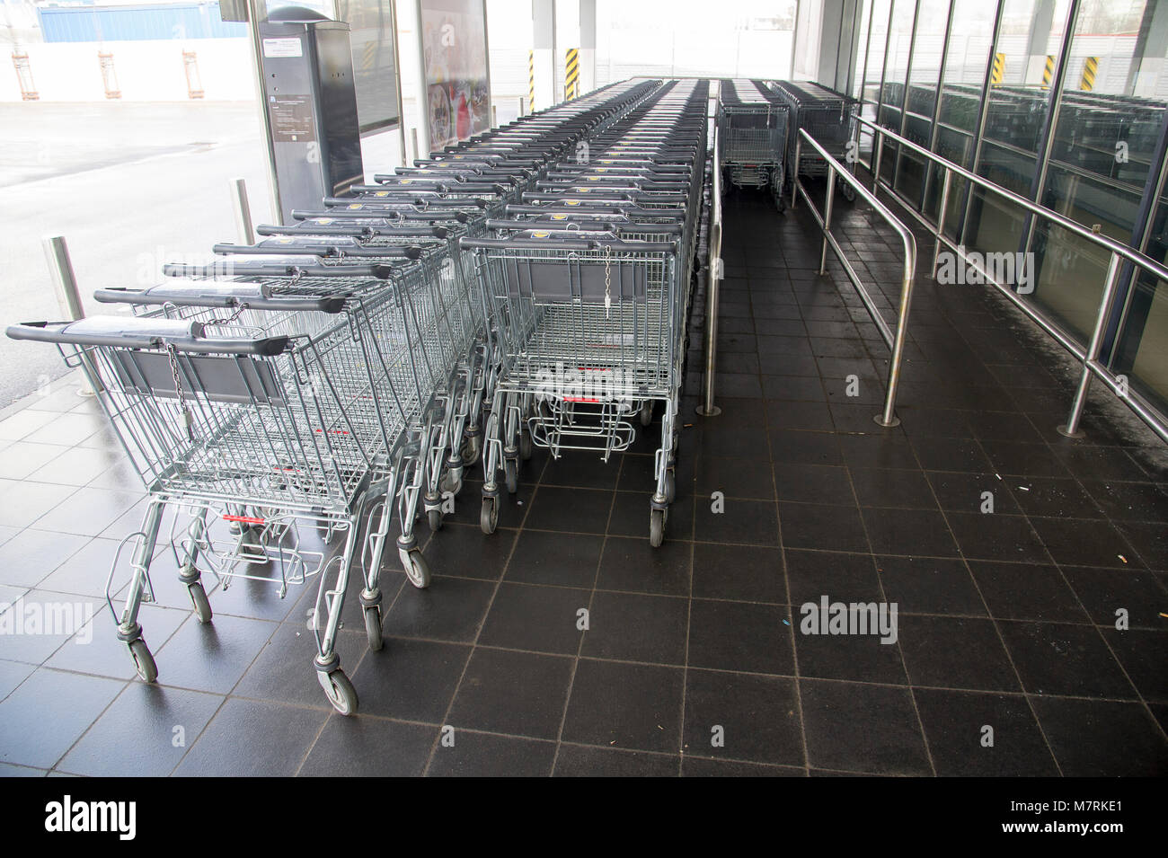 Parked shopping carts equipped with coin-operated locking mechanisms in ...