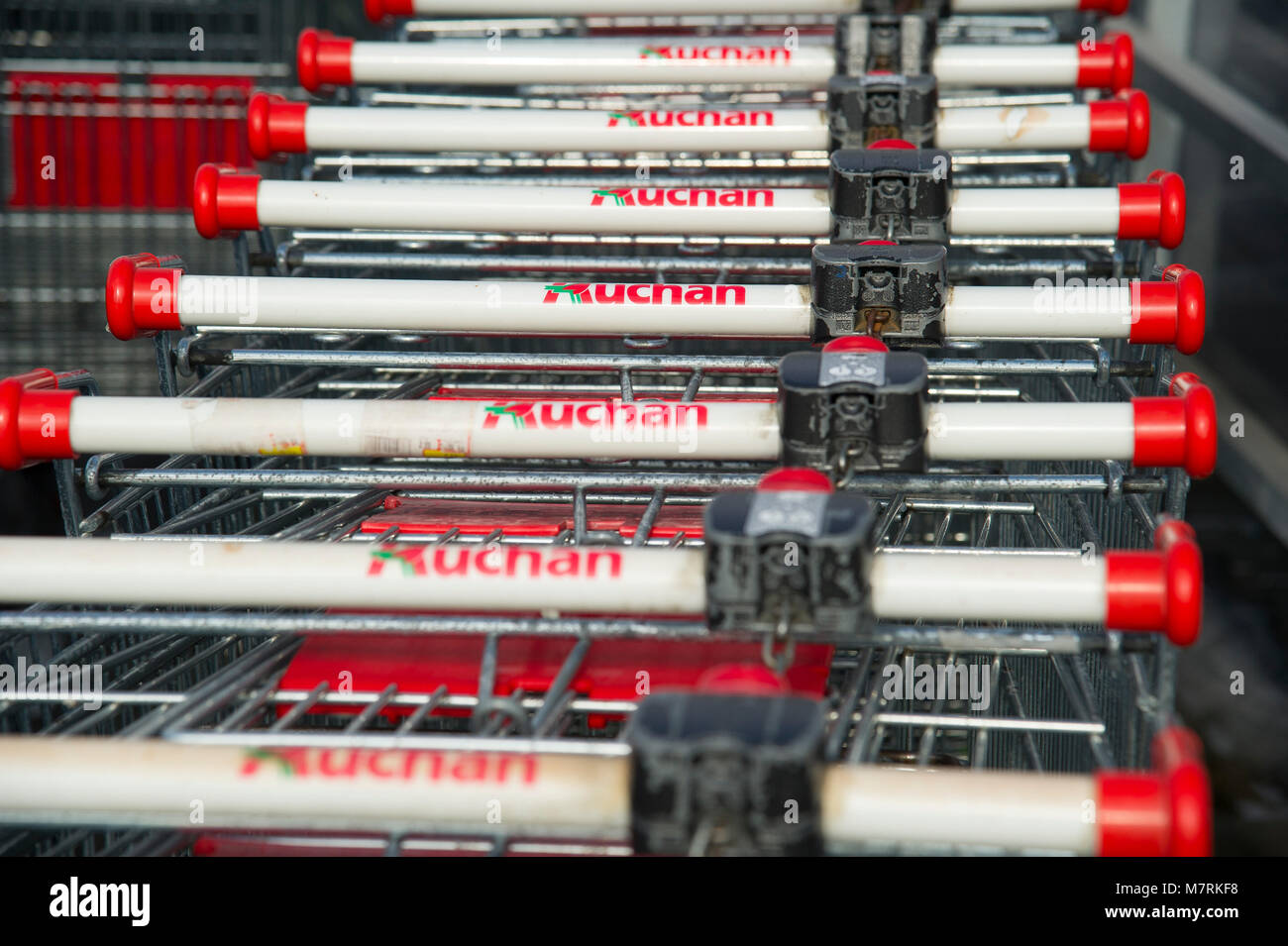 Parked shopping carts equipped with coin-operated locking mechanisms in ...