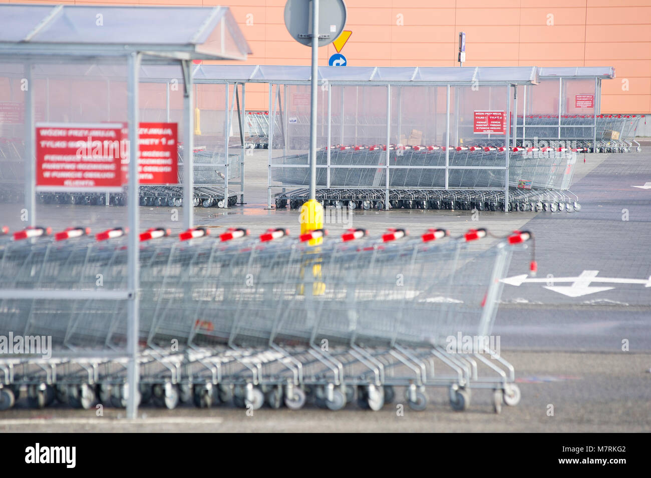 Parked shopping carts equipped with coin-operated locking mechanisms in ...