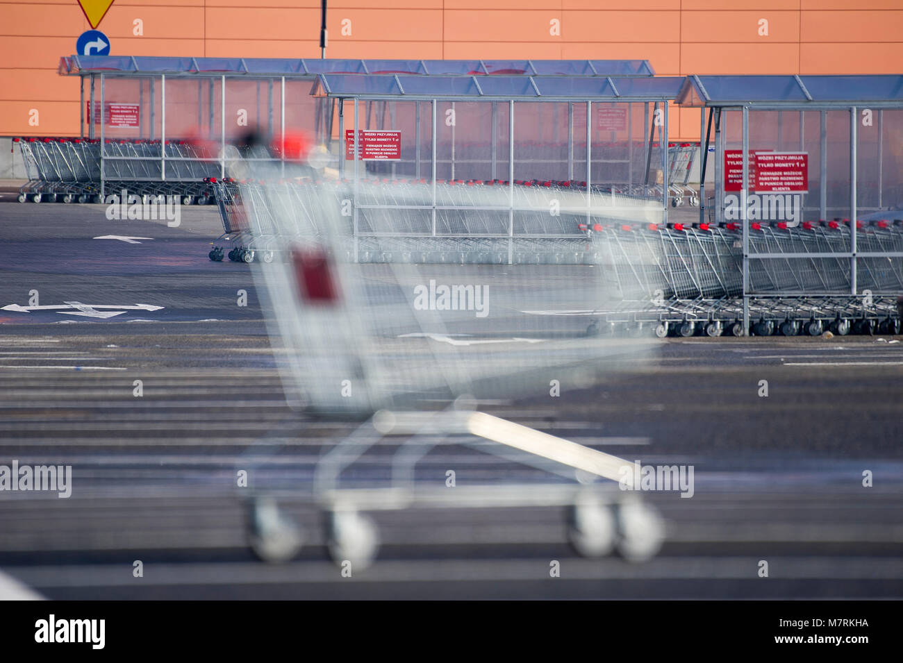 Parked shopping carts equipped with coin-operated locking mechanisms in ...