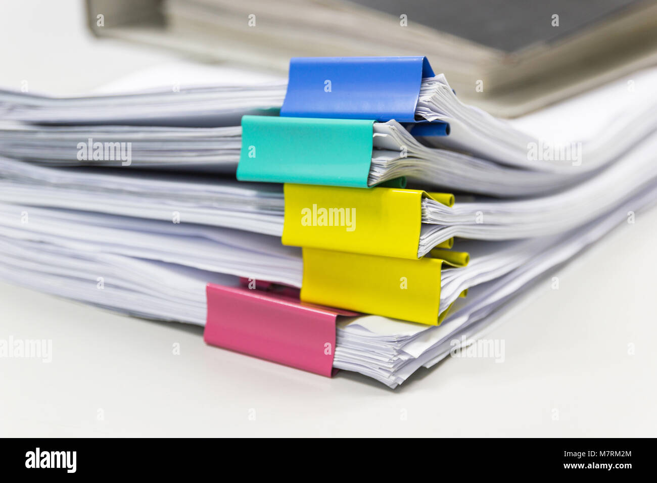 Stack of papers documents in archives files with paper clips on desk at ...