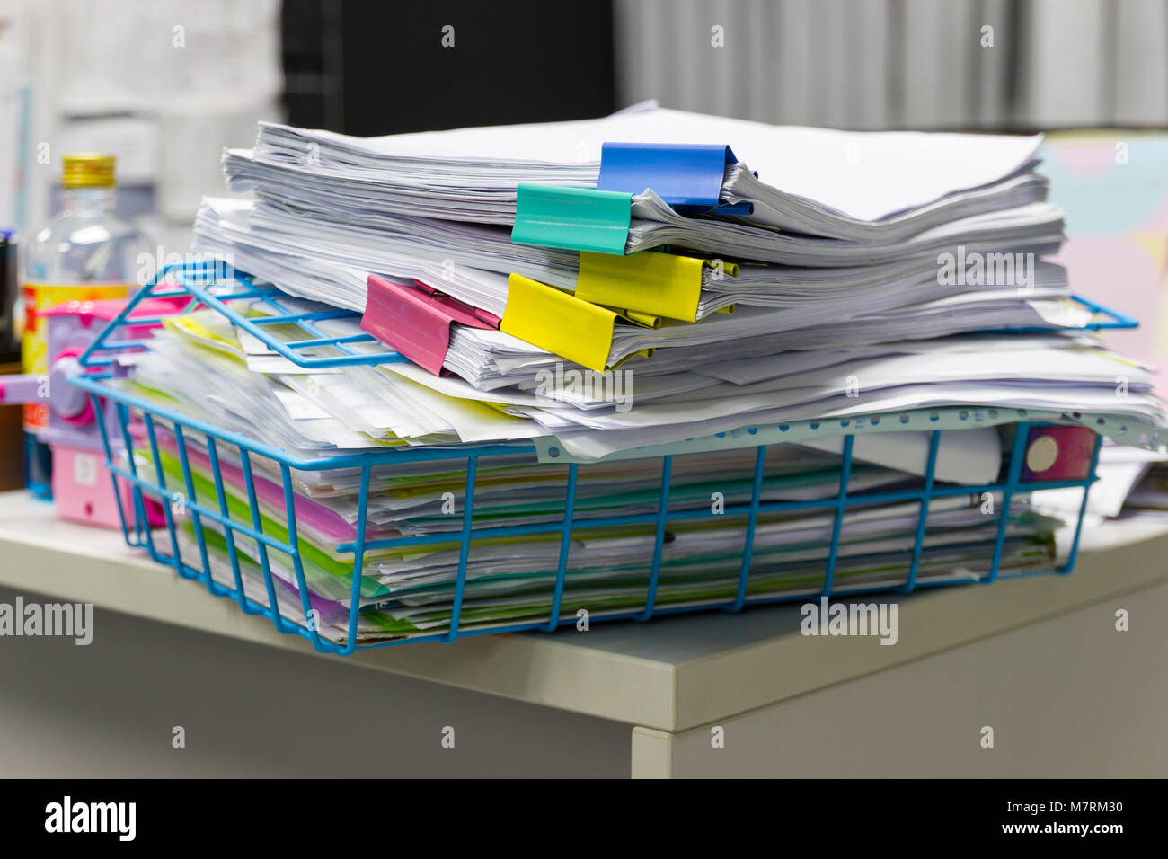 Stack of papers documents in archives files with paper clips on desk at ...