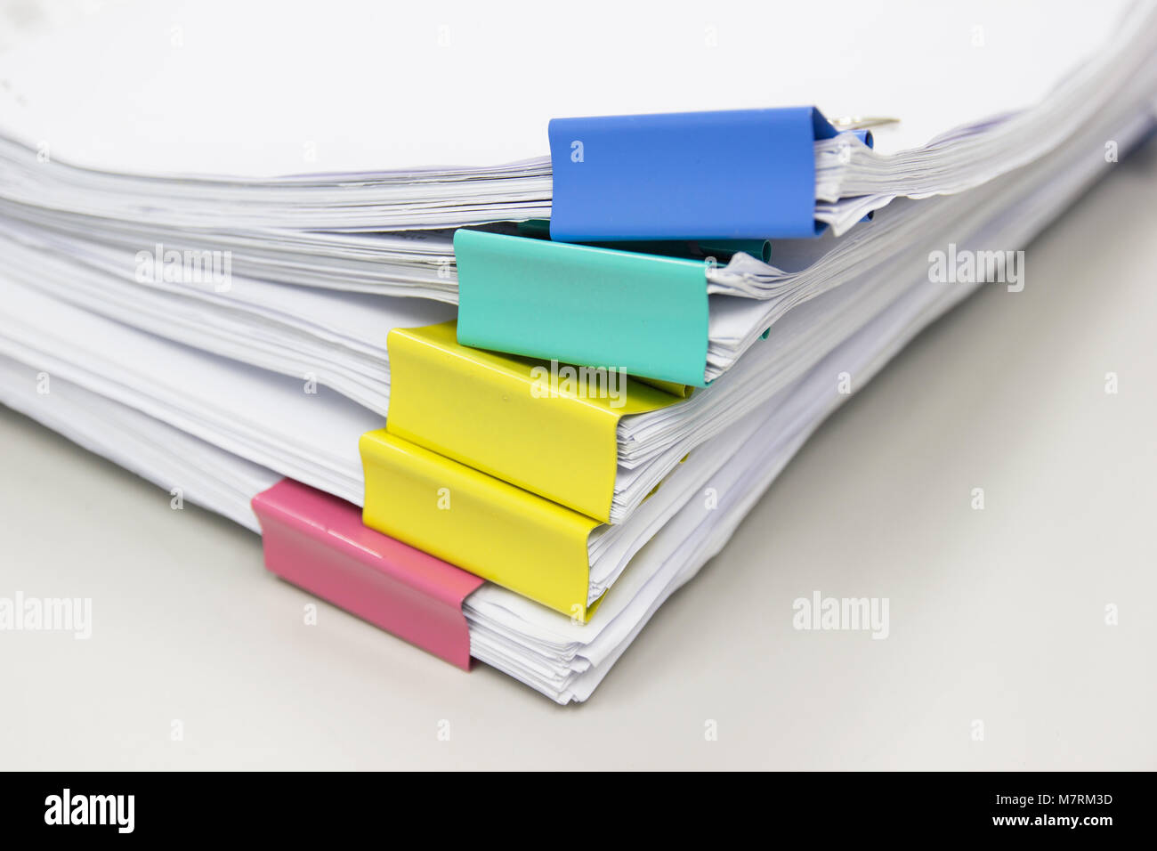 Stack of papers documents in archives files with paper clips on desk at ...