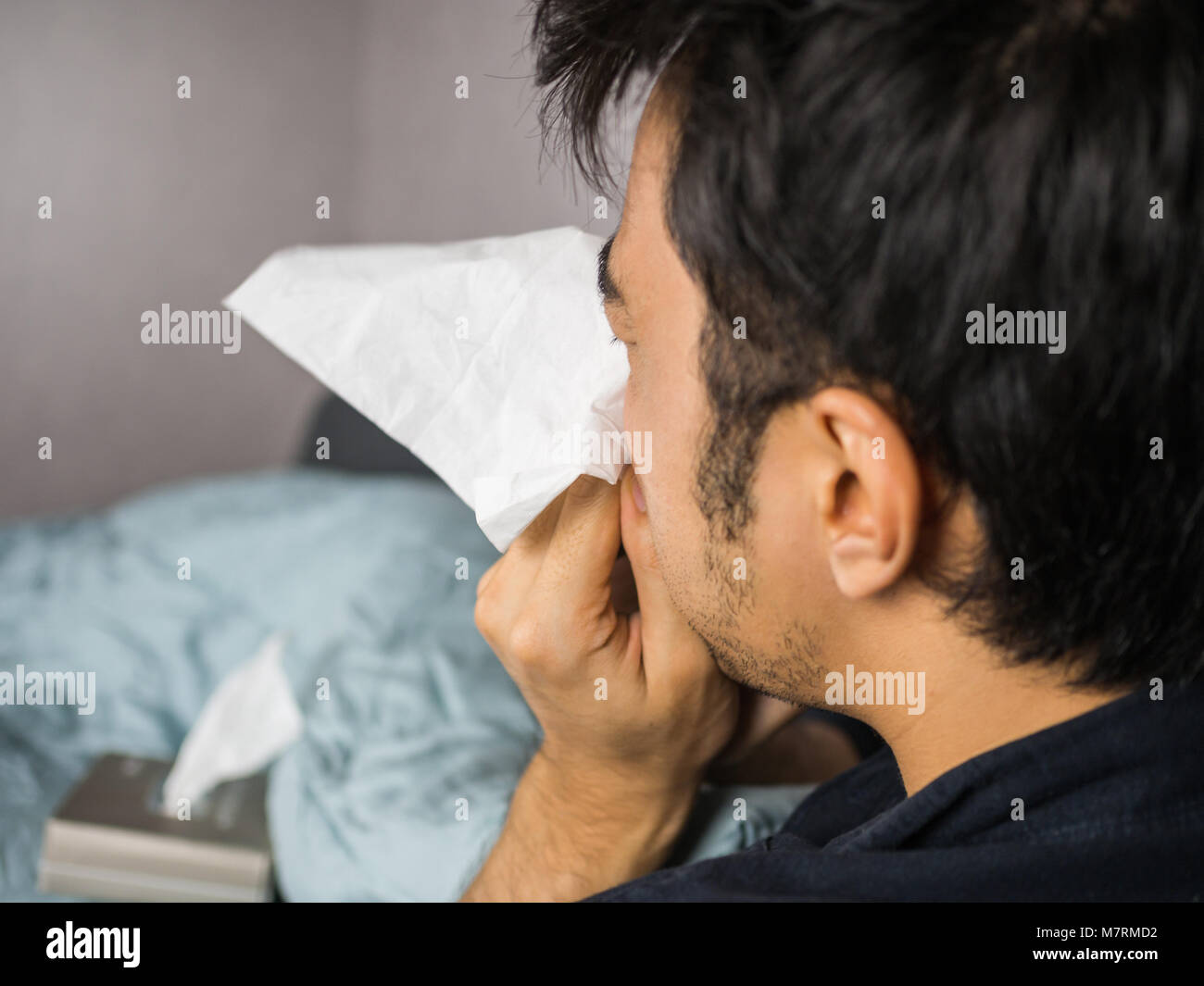 Man blow his nose with tissue paper flying Stock Photo - Alamy