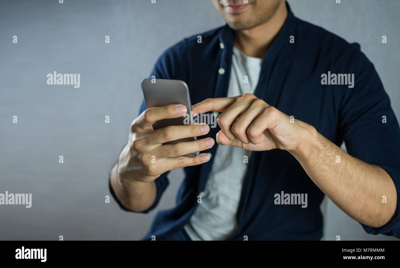 Man sliding phone screen and smile Stock Photo - Alamy