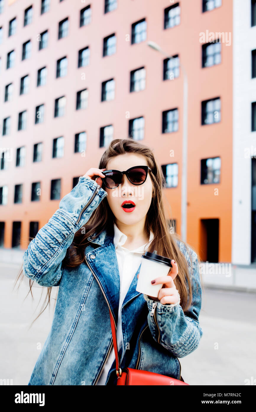 young pretty brunette business woman posing against modern build Stock ...
