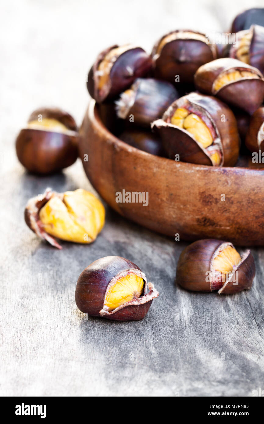 Roasted sweet chestnuts in wooden bowl Stock Photo - Alamy