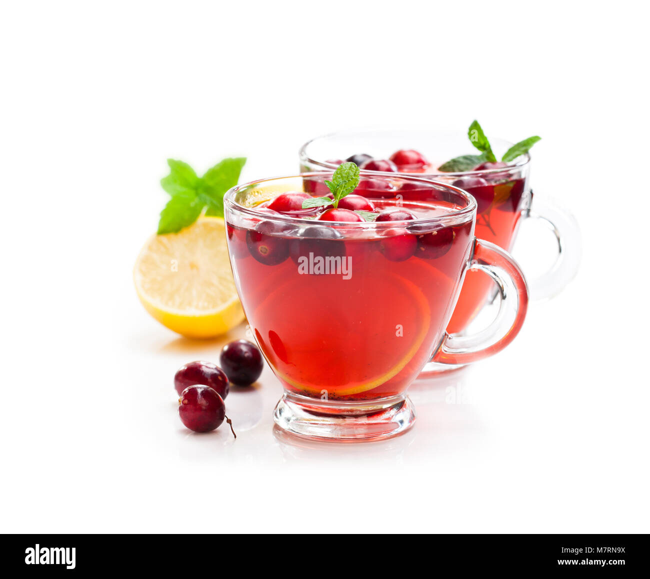 Red fruit tea with lemon and cranberry isolated on white background ...