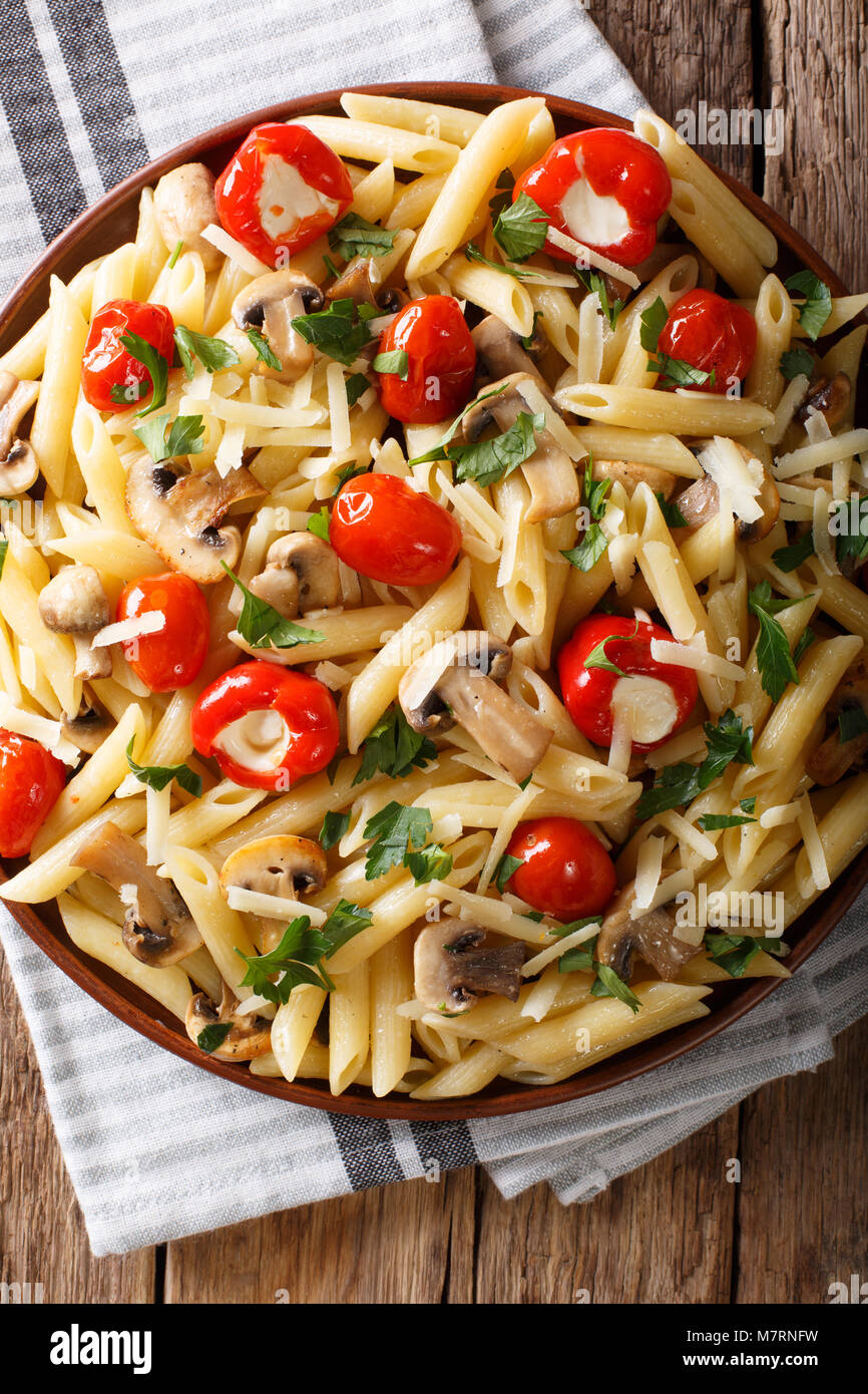 Italian Penne pasta with fried mushrooms, tomatoes, pepper and Parmesan ...