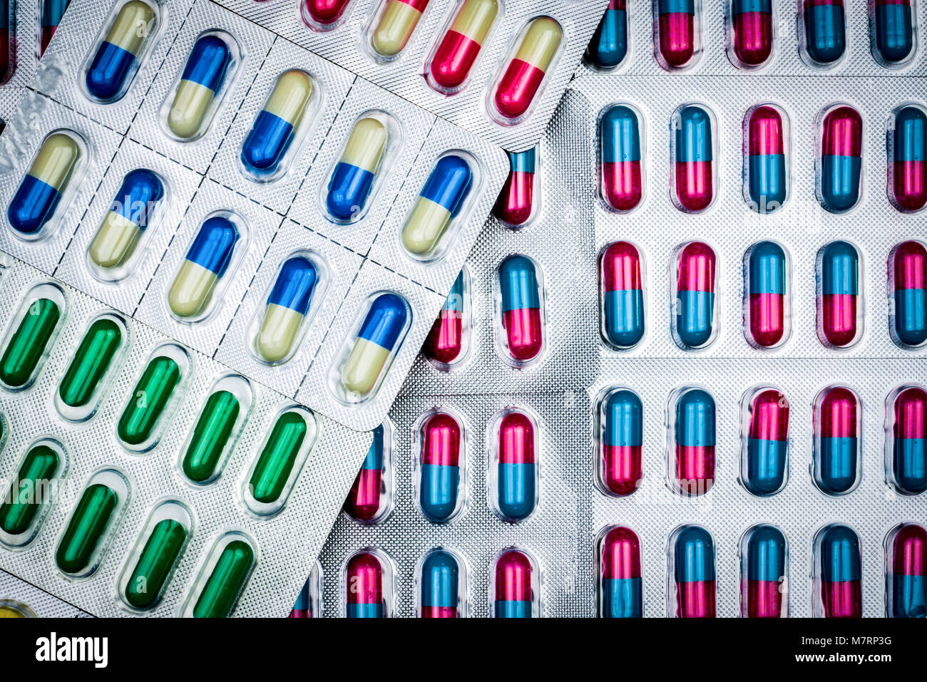 Top view of colorful tablets and capsules pills in blister packs ...