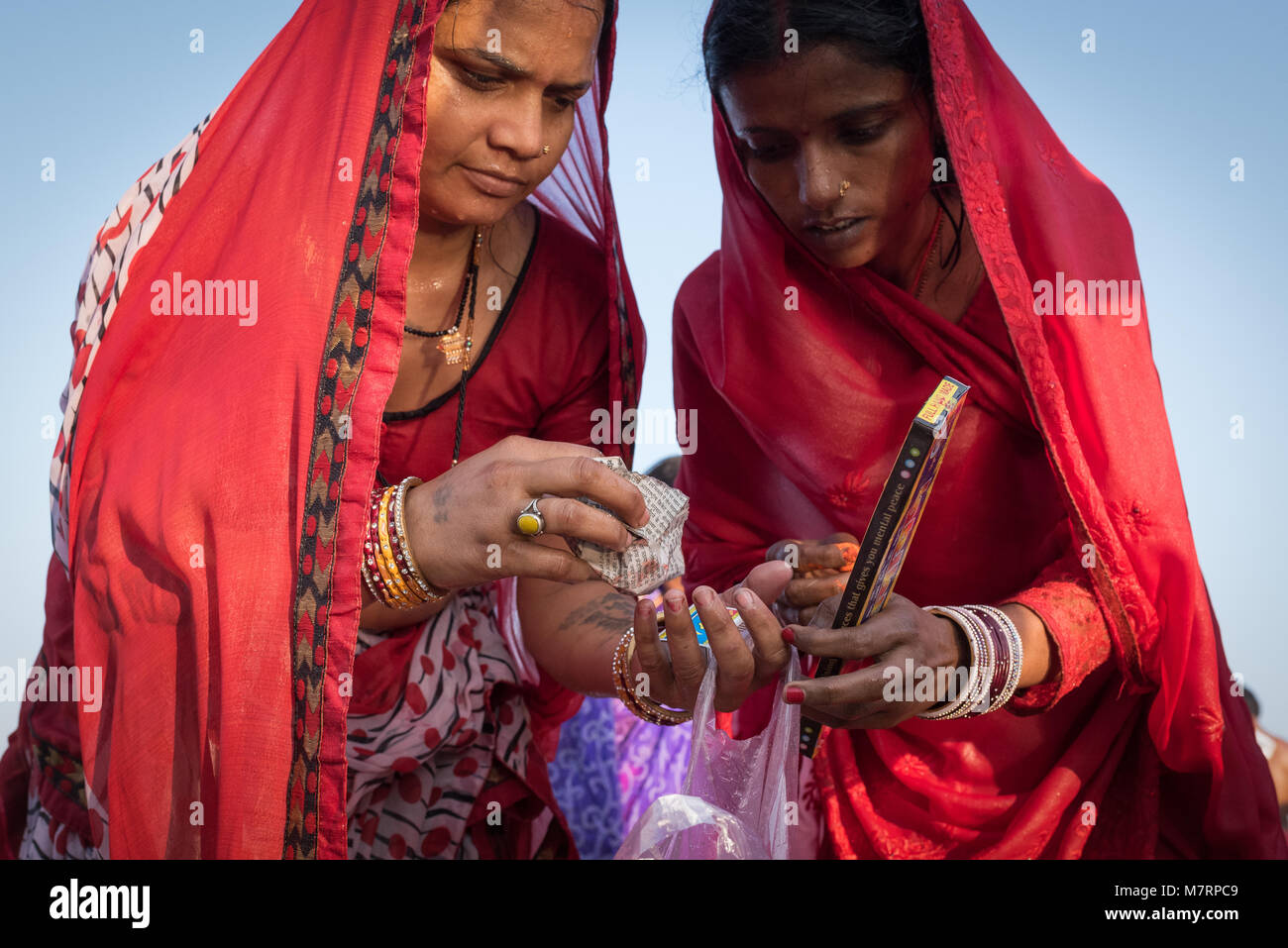 Pilgrims lighting incense at the Kartika Purnima (Deva-Diwali) festival ...