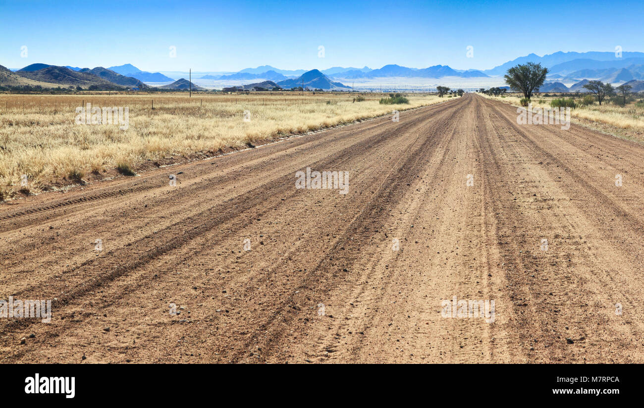 Adventurous drive on a rough gravel road through the desert towards the ...