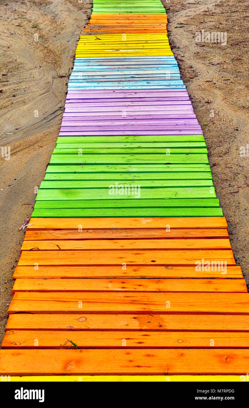 Coloured wooden boardwalks on beach sand Stock Photo - Alamy