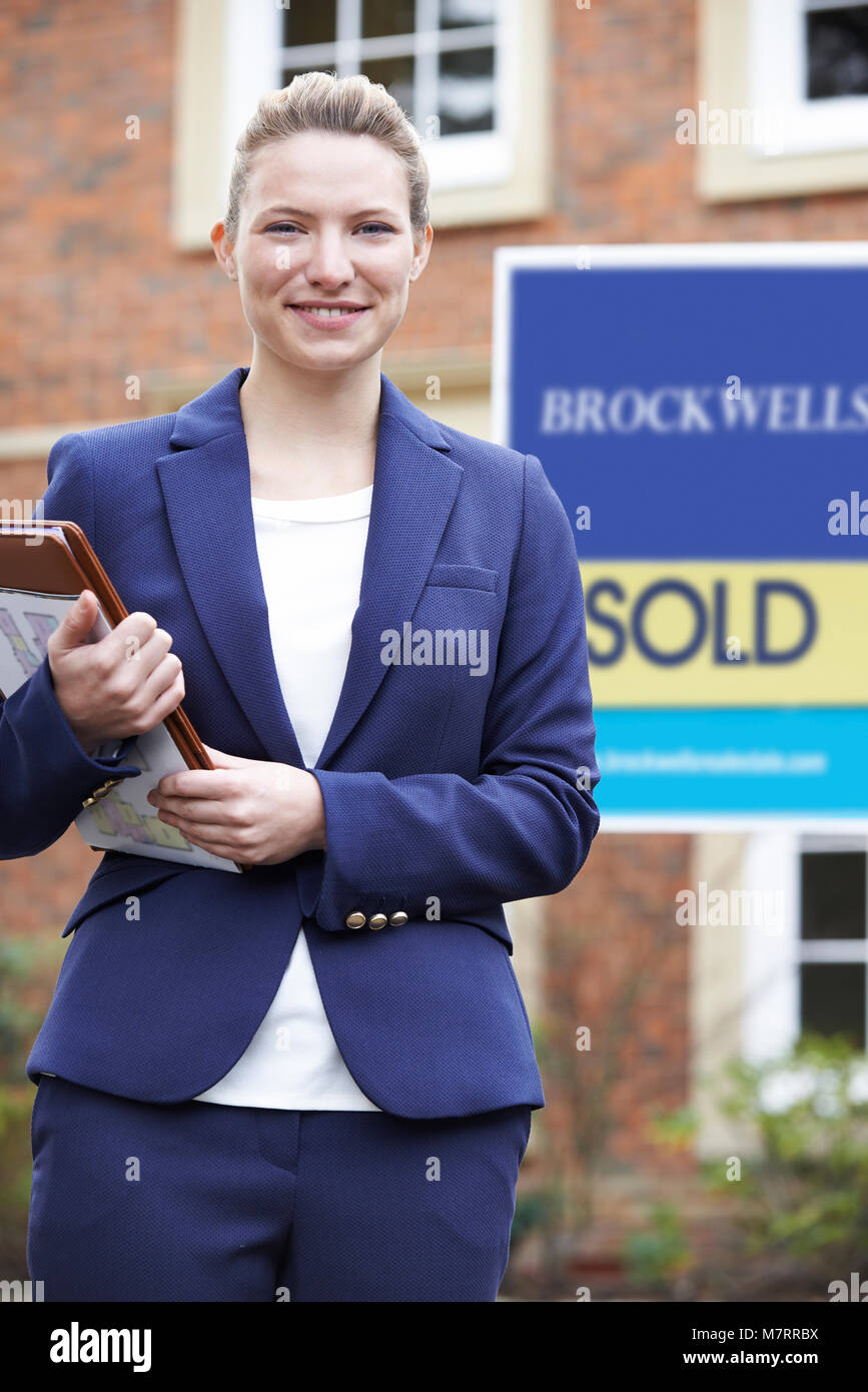 Portrait Of Female Realtor Standing Outside Residential Property Stock ...