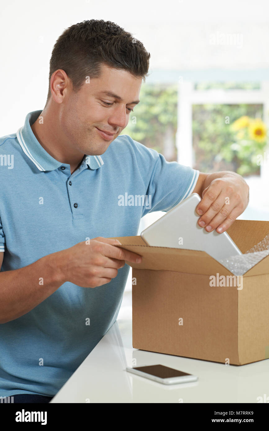 Man unwrapping box hi-res stock photography and images - Alamy