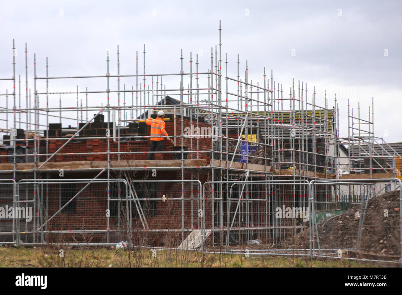 Bricklayer working on the construction of a new house in a residential ...