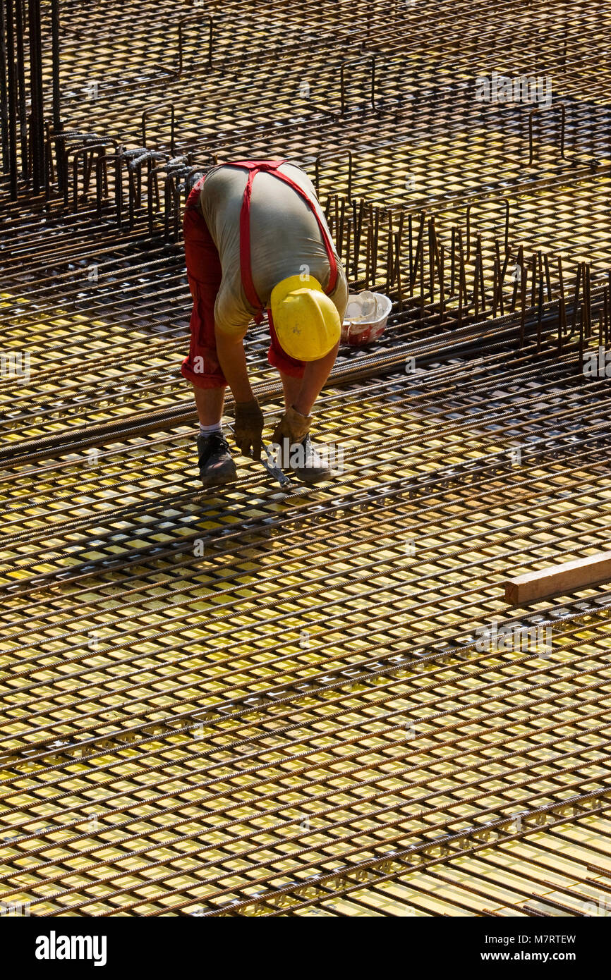 Construction worker between steel bars Stock Photo - Alamy
