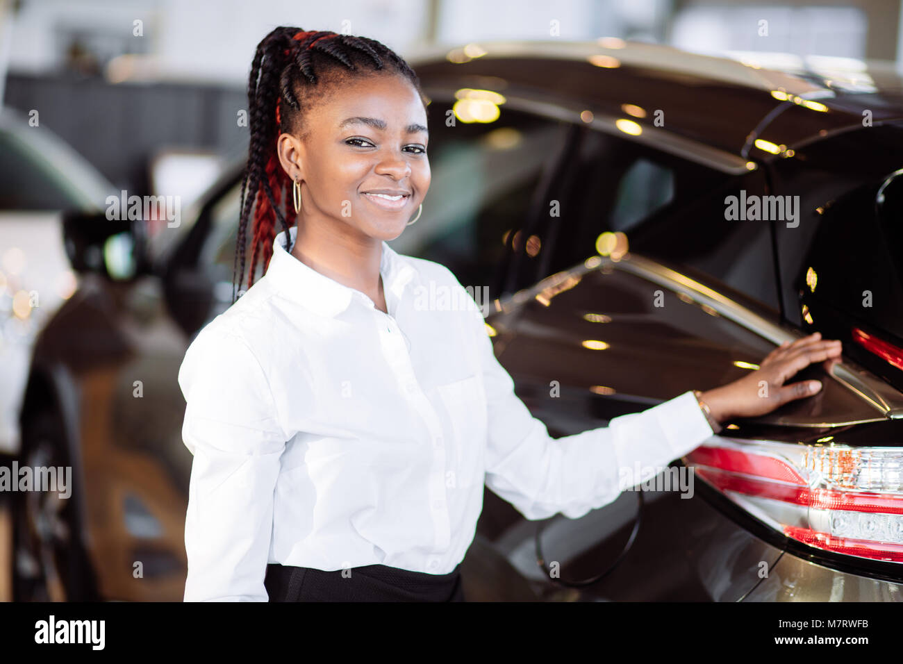 Car dealer woman. Auto dealership and rental concept background Stock ...