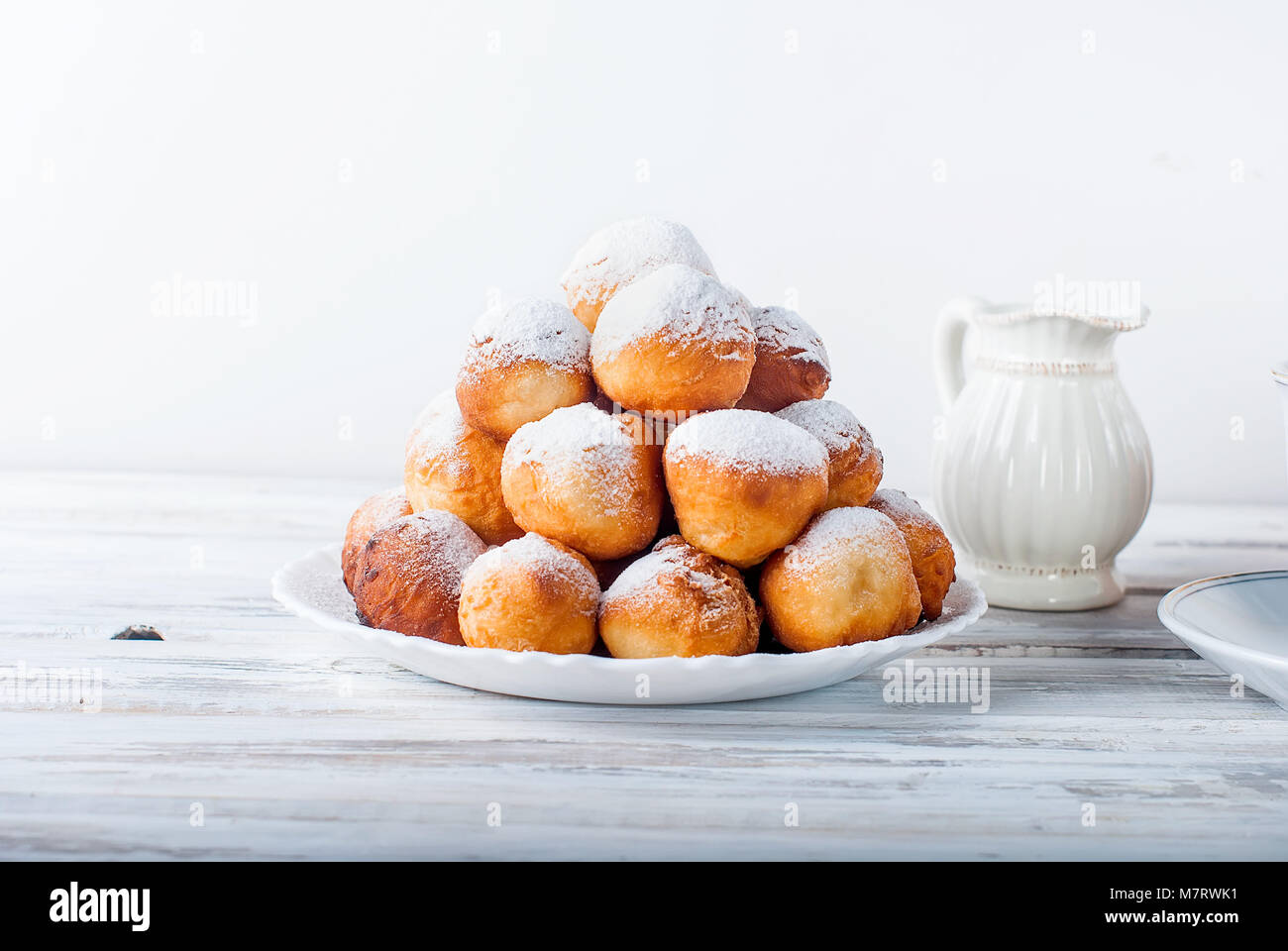sweet donuts laid out pyramid sprinkled with powdered sugar on the ...