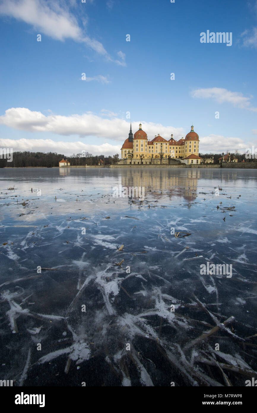 Castle Moritzburg in Dresden with reflections in the ice in the winter ...