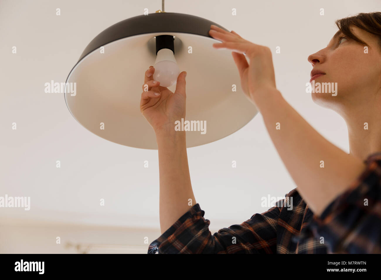 Woman replacing light bulb at home. Power save LED lamp changing Stock ...