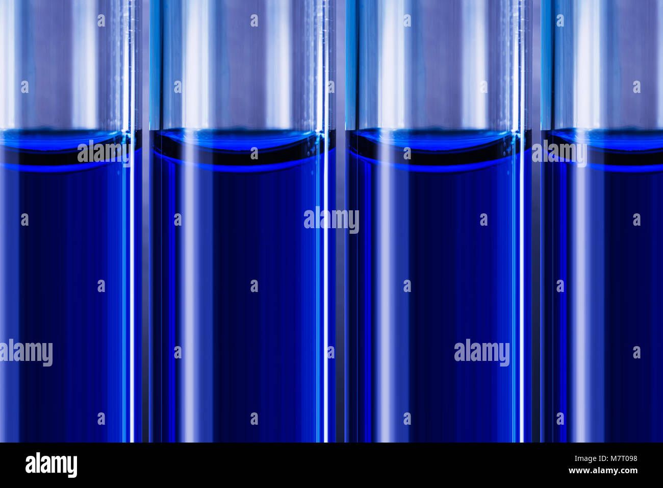 Blue liquid in tubes on blured medical background Stock Photo - Alamy