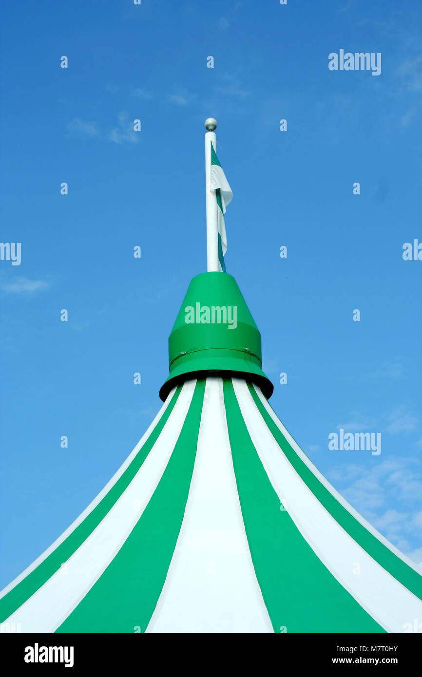 Green and white circus tent top against blue sky Stock Photo - Alamy