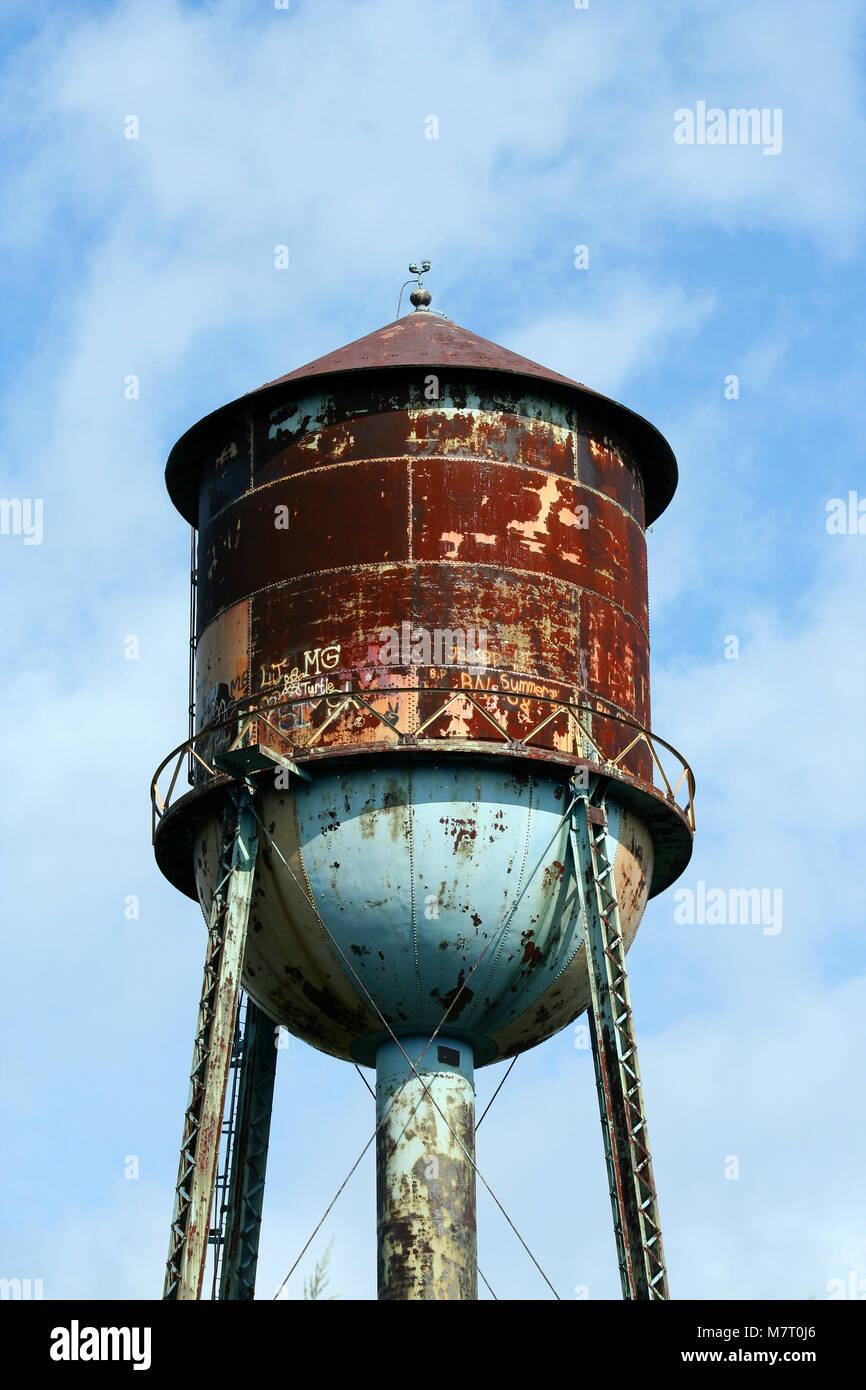 A Old rusty watertower against blue sky Stock Photo - Alamy