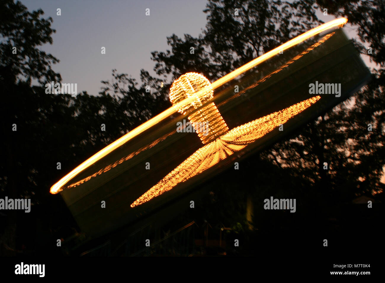 Long exposure of a spinning Amusement park ride Stock Photo - Alamy